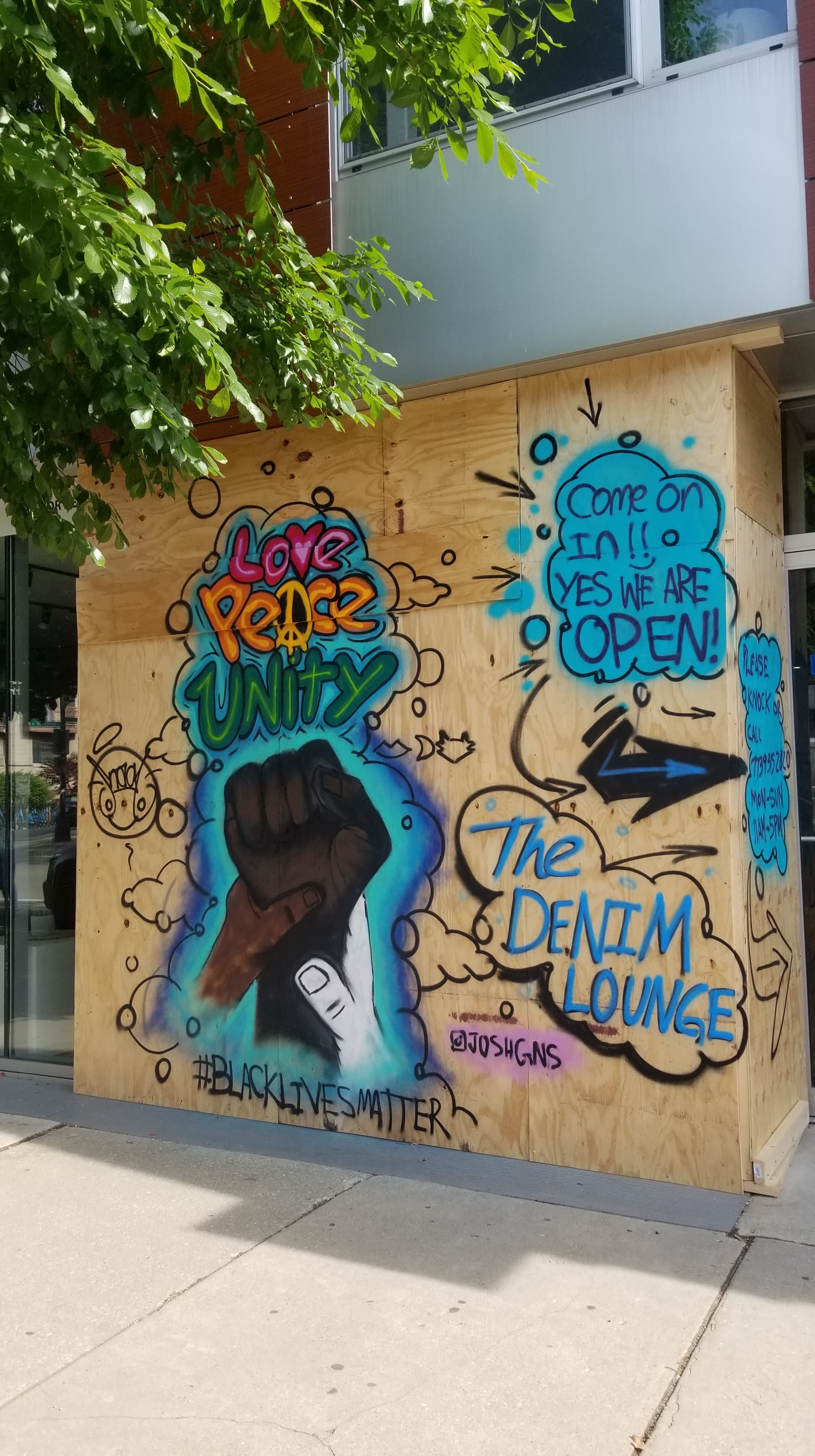 Artists create images of hope and unity to replace boarded up store ...